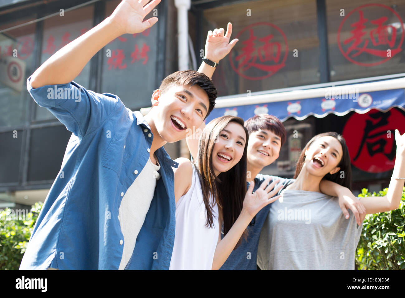 Young couples waving hands Stock Photo - Alamy