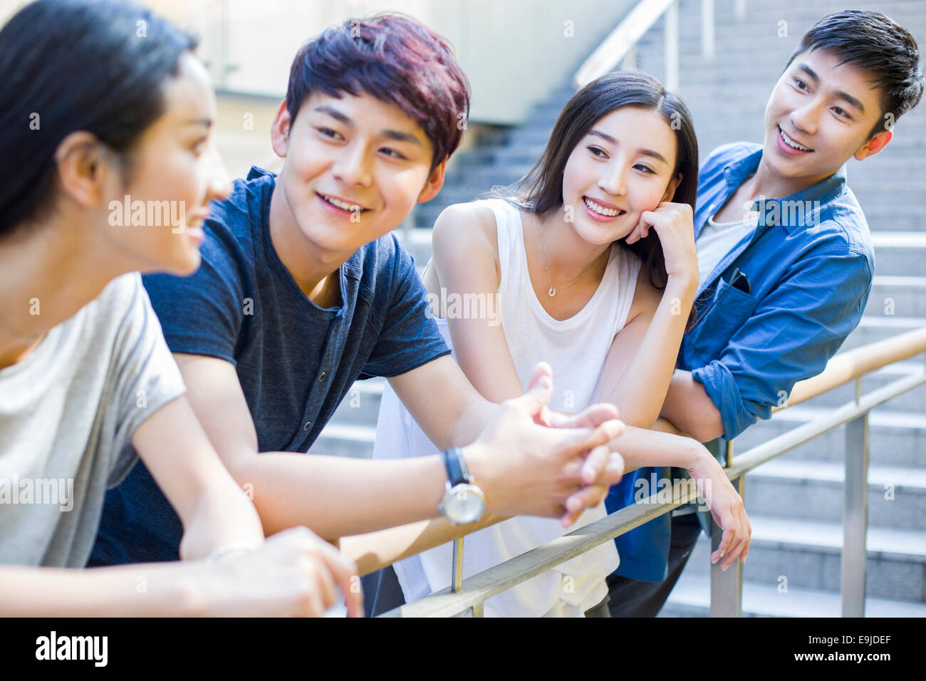 Happy young friends standing together Stock Photo - Alamy
