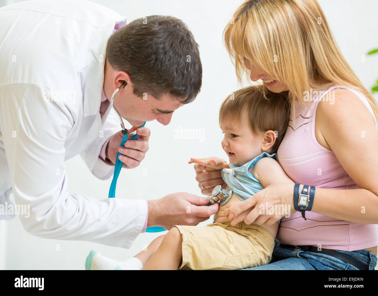 doctor examining kid patient with stethoscope Stock Photo - Alamy