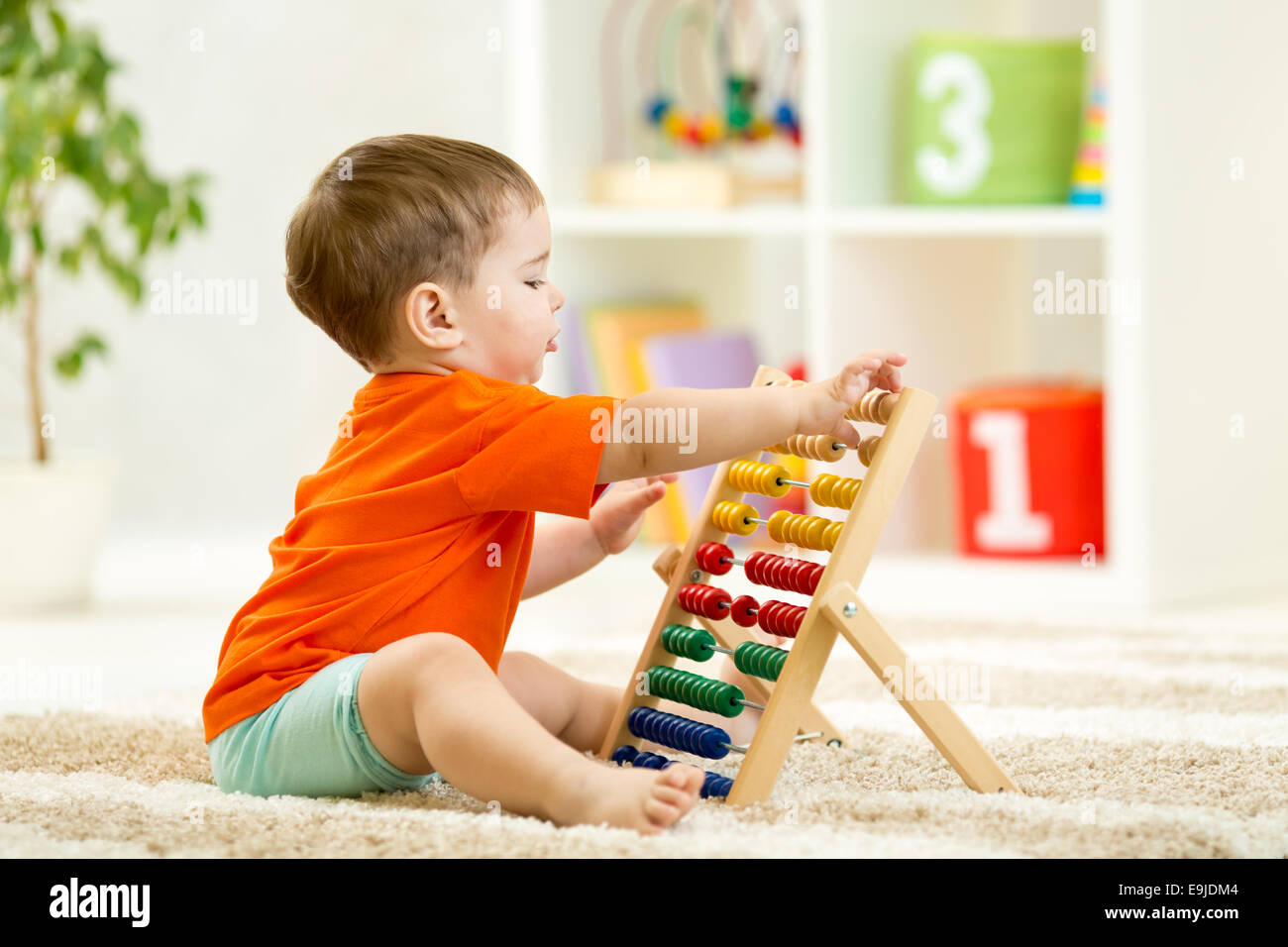 child boy playing with counter Stock Photo - Alamy