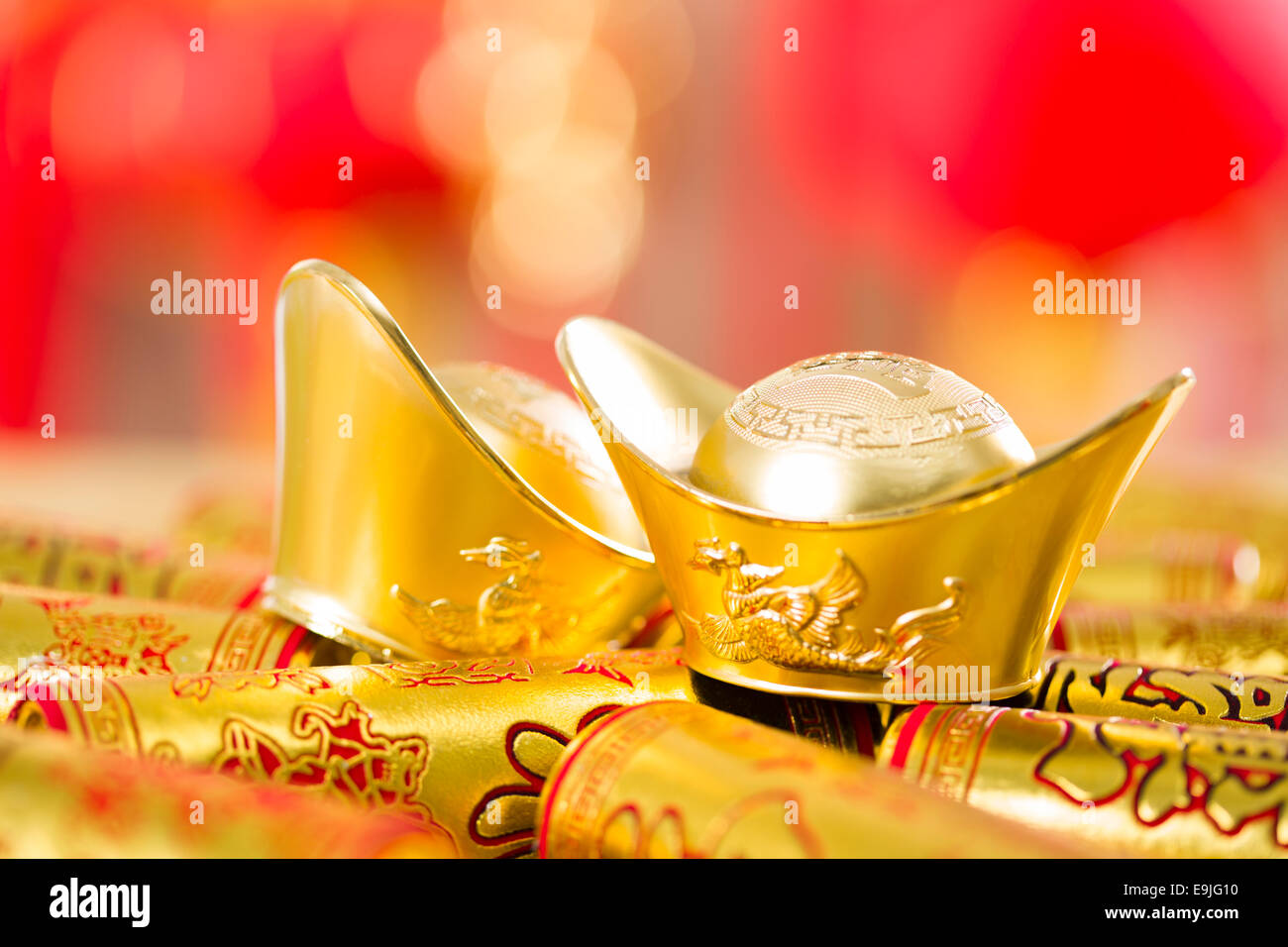 Chinese traditional currency yuanbao and firecrackers Stock Photo - Alamy