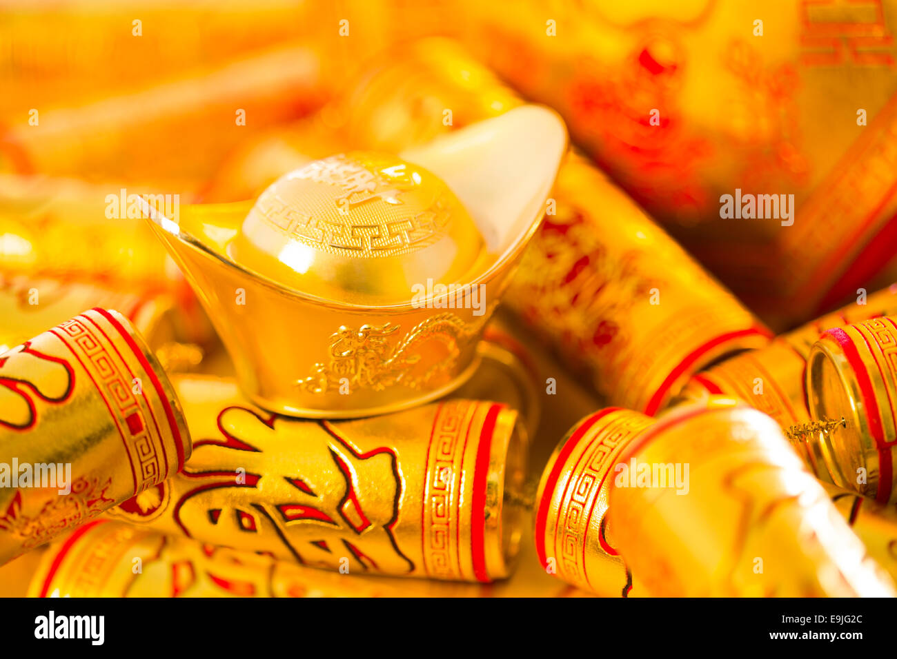 Chinese traditional currency yuanbao and firecrackers Stock Photo - Alamy