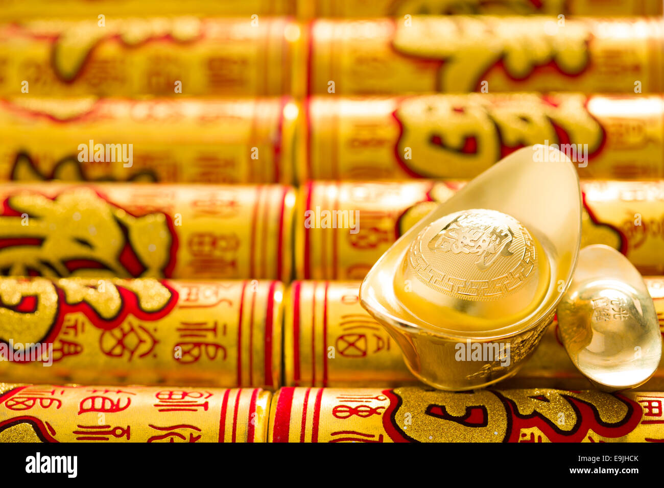 Chinese traditional currency yuanbao and firecrackers Stock Photo - Alamy