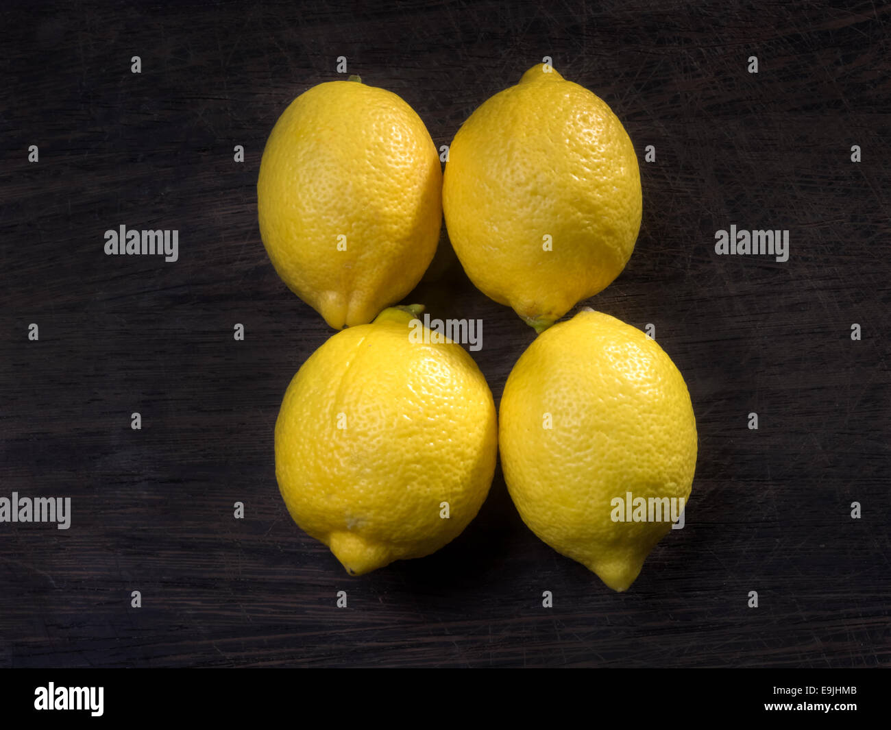 Four ripe organic lemons on a dark background Stock Photo - Alamy