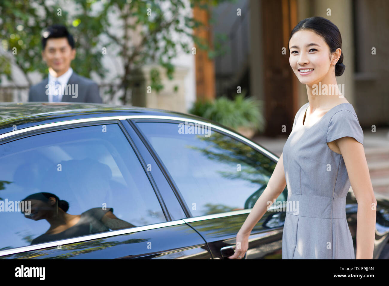 Young woman opening car door Stock Photo - Alamy Young woman opening car door Stock Photo - Alamy