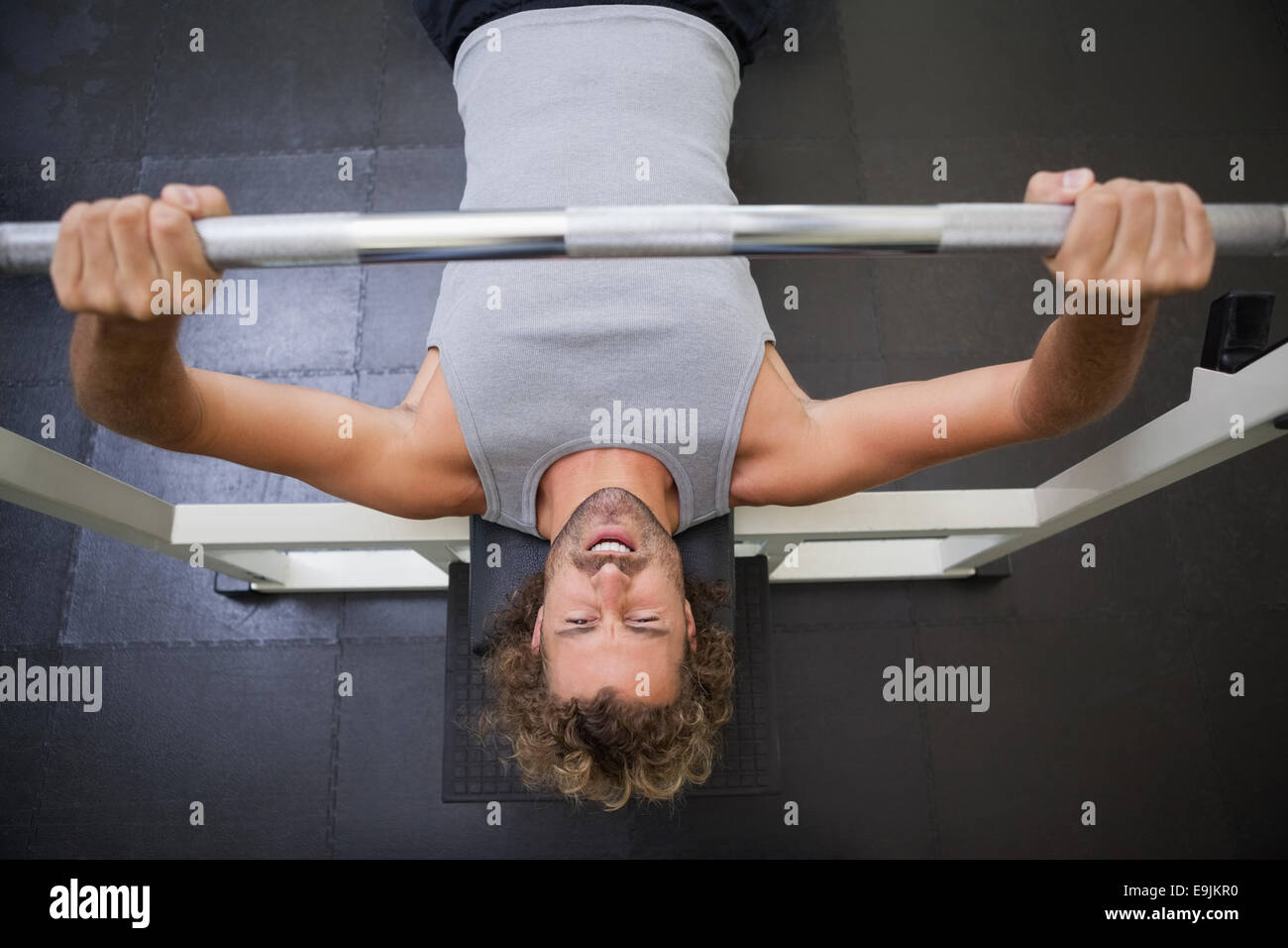 Muscular man lifting barbell in gym Stock Photo - Alamy