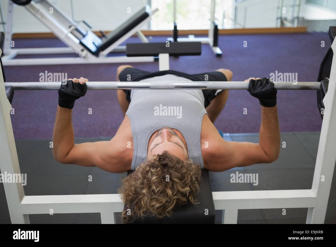 Young muscular man lifting barbell in gym Stock Photo - Alamy