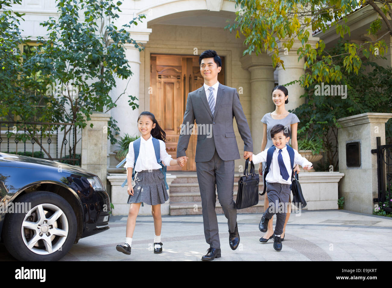 Young couple sending their children to school Stock Photo - Alamy