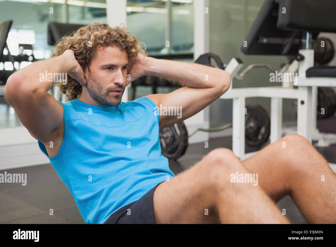 Handsome man doing abdominal crunches in gym Stock Photo - Alamy