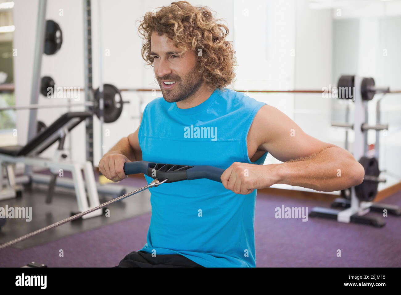Handsome man using resistance band in gym Stock Photo - Alamy