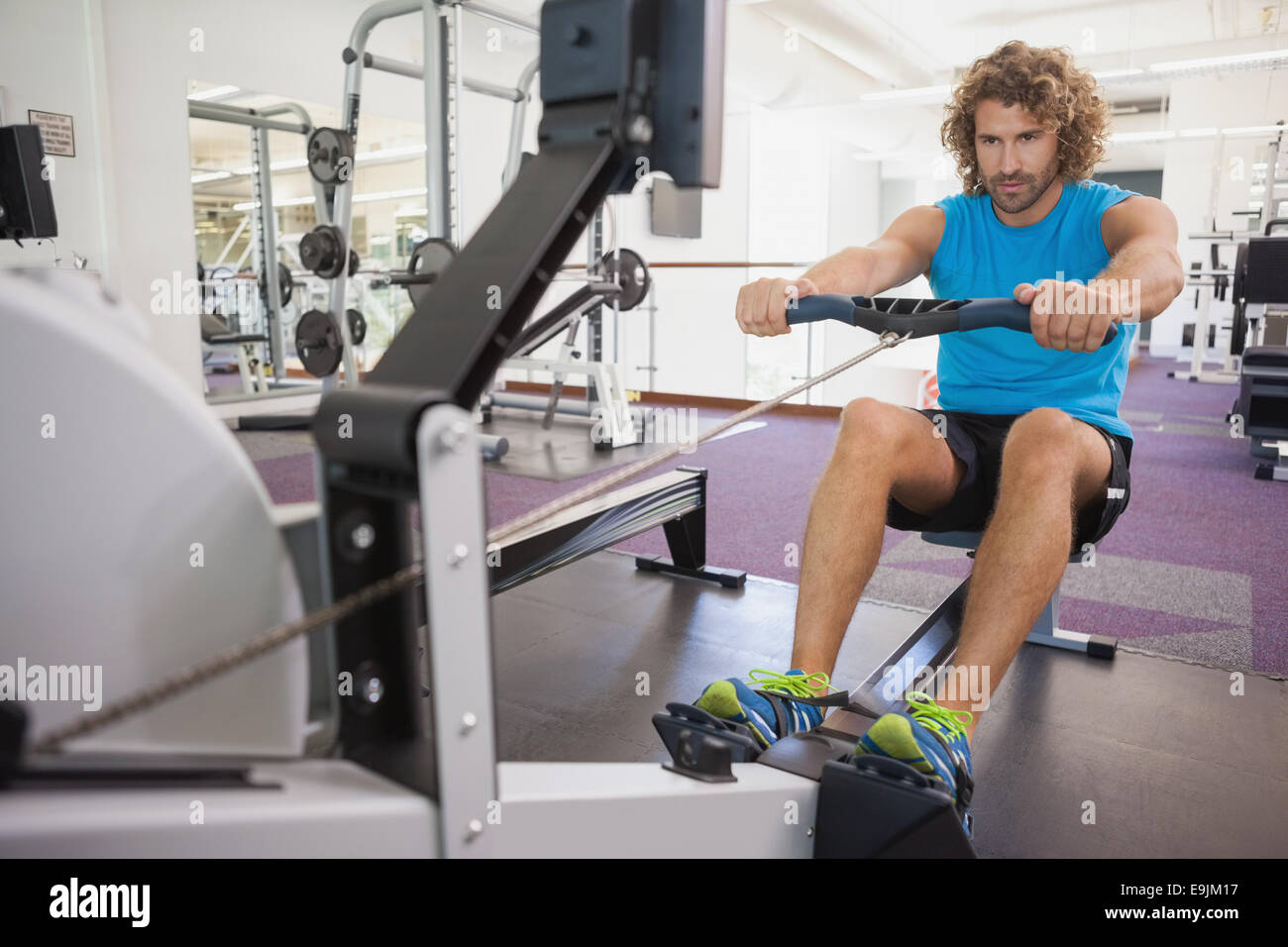 Handsome man using resistance band in gym Stock Photo - Alamy
