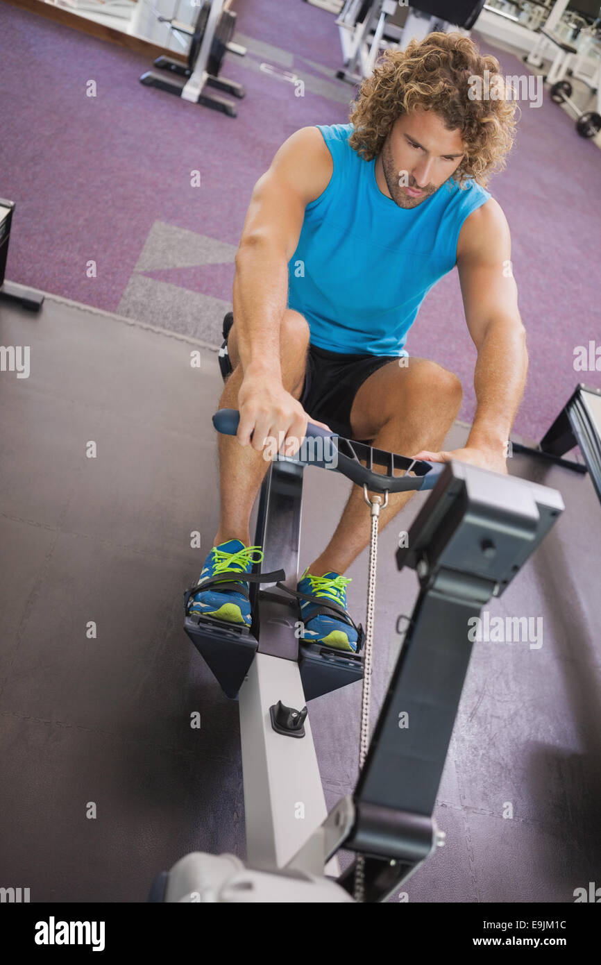 Handsome young man using resistance band in gym Stock Photo - Alamy