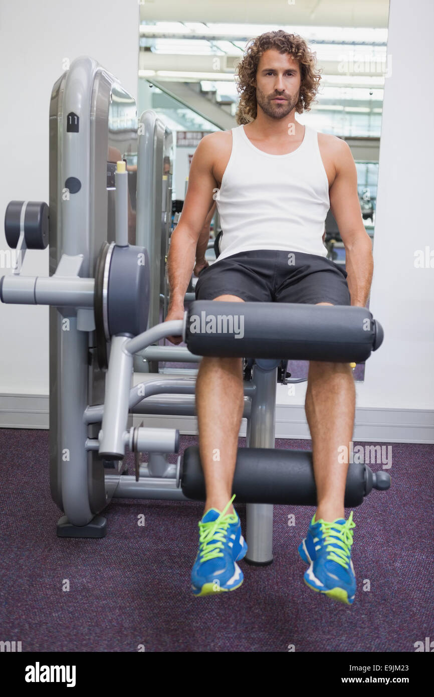 Portrait of handsome man doing leg workout at gym Stock Photo - Alamy