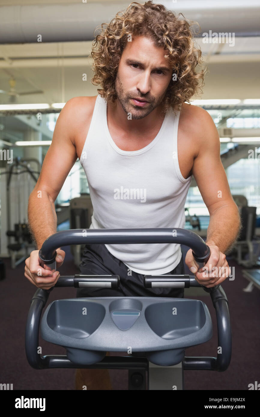 Fit man using exercise bike Stock Photo - Alamy