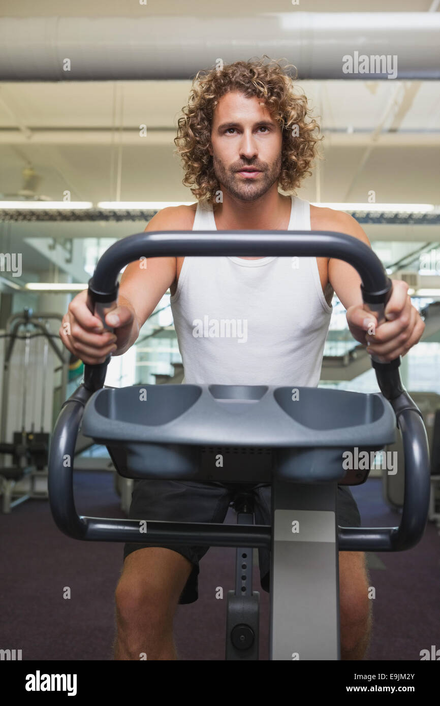 Man working out on exercise bike at gym Stock Photo - Alamy