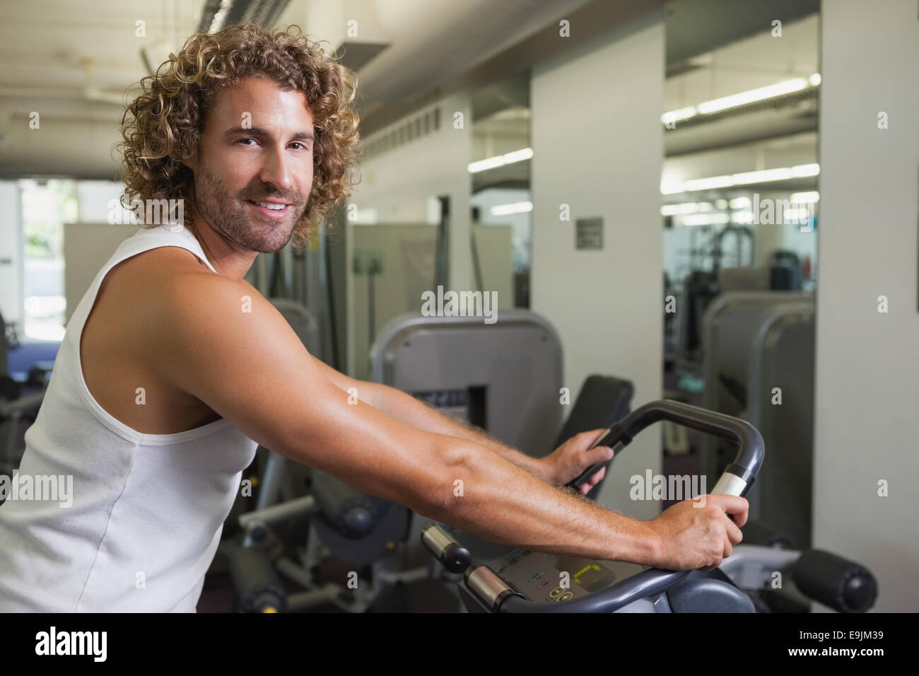 Side view portrait of man working out on exercise bike Stock Photo - Alamy