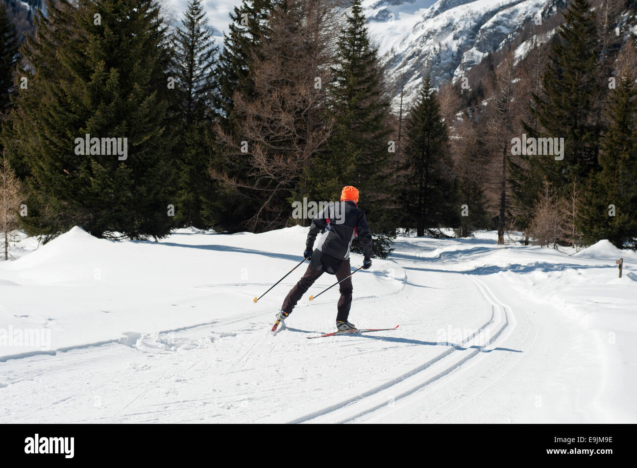 cross-country skier in sunny mountain landscape Stock Photo - Alamy