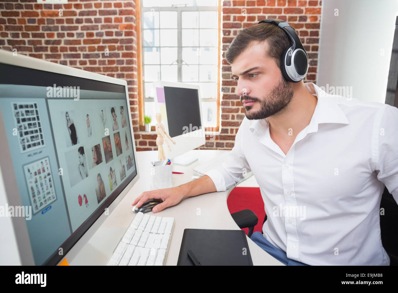 Concentrated photo editor using computer in office Stock Photo - Alamy