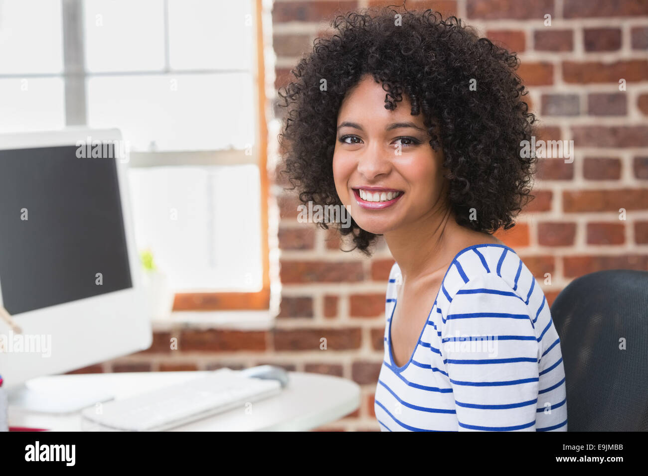 Smiling female photo editor using computer in office Stock Photo - Alamy