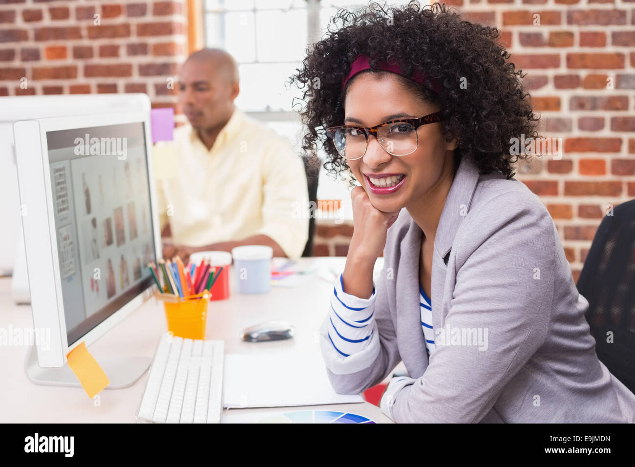 Female photo editor at office desk Stock Photo - Alamy