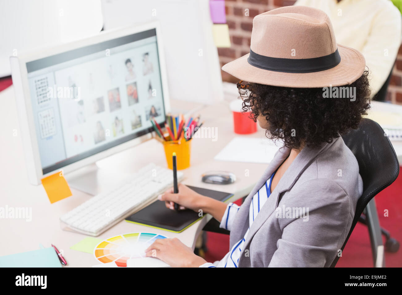 Female photo editor using digitizer in office Stock Photo - Alamy