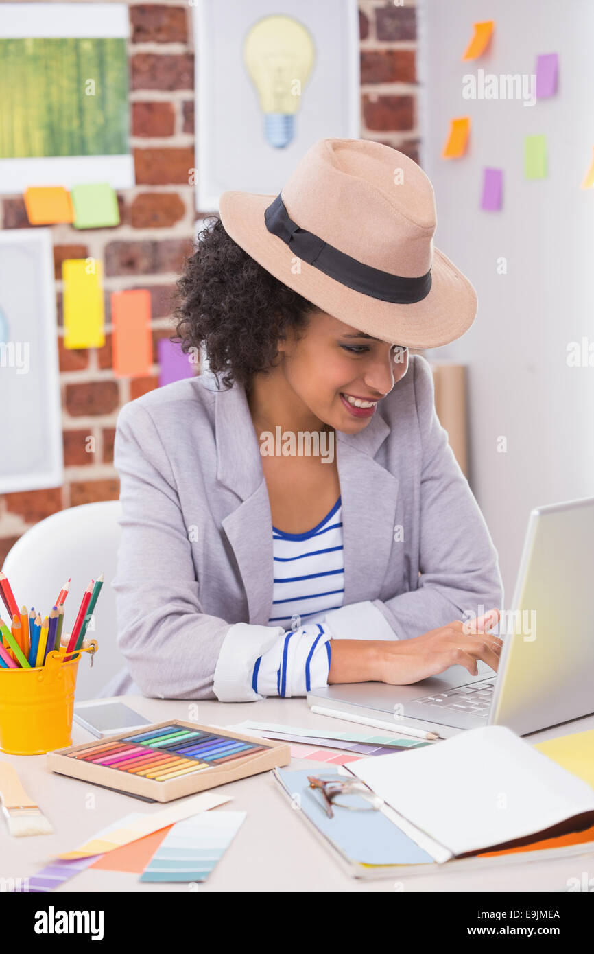 Female interior designer using laptop at desk Stock Photo - Alamy