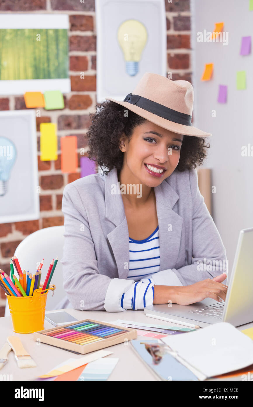 Female interior designer using laptop at desk Stock Photo - Alamy