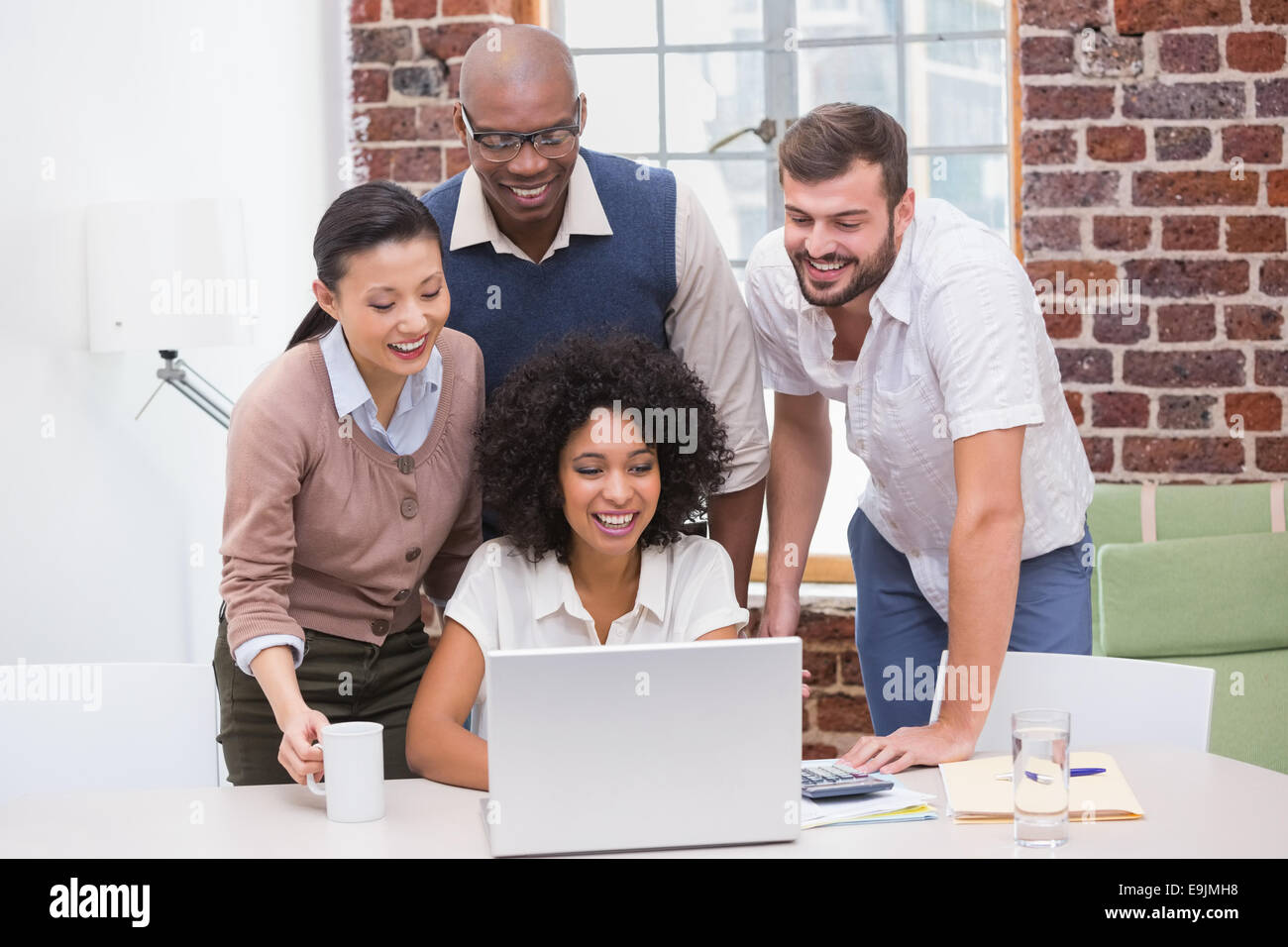 Creative business team using laptop in meeting Stock Photo - Alamy