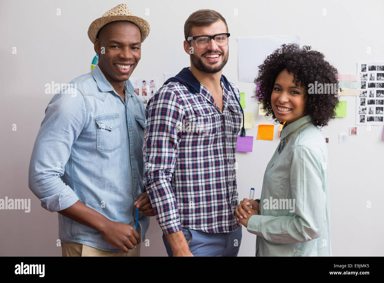 Team with sticky notes on wall Stock Photo - Alamy