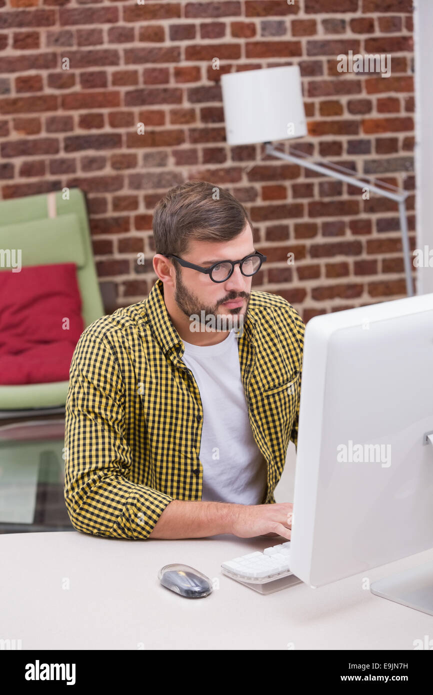 Serious casual young man using computer Stock Photo - Alamy