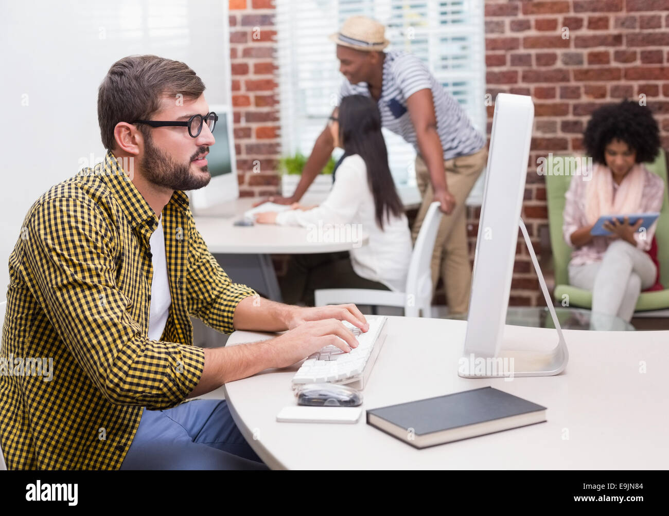 Concentrated casual man using computer Stock Photo - Alamy