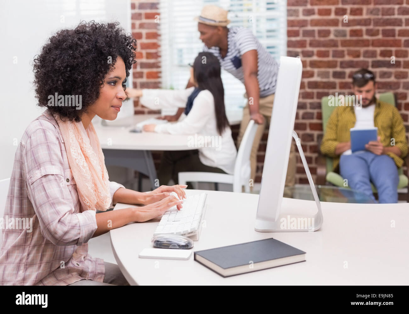 Concentrated casual woman using computer Stock Photo - Alamy