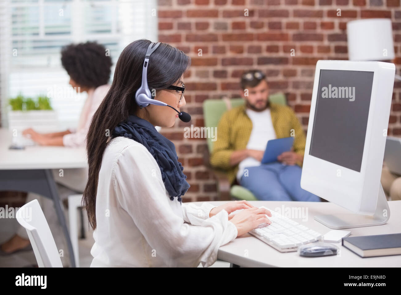 Concentrated casual young woman using computer Stock Photo - Alamy