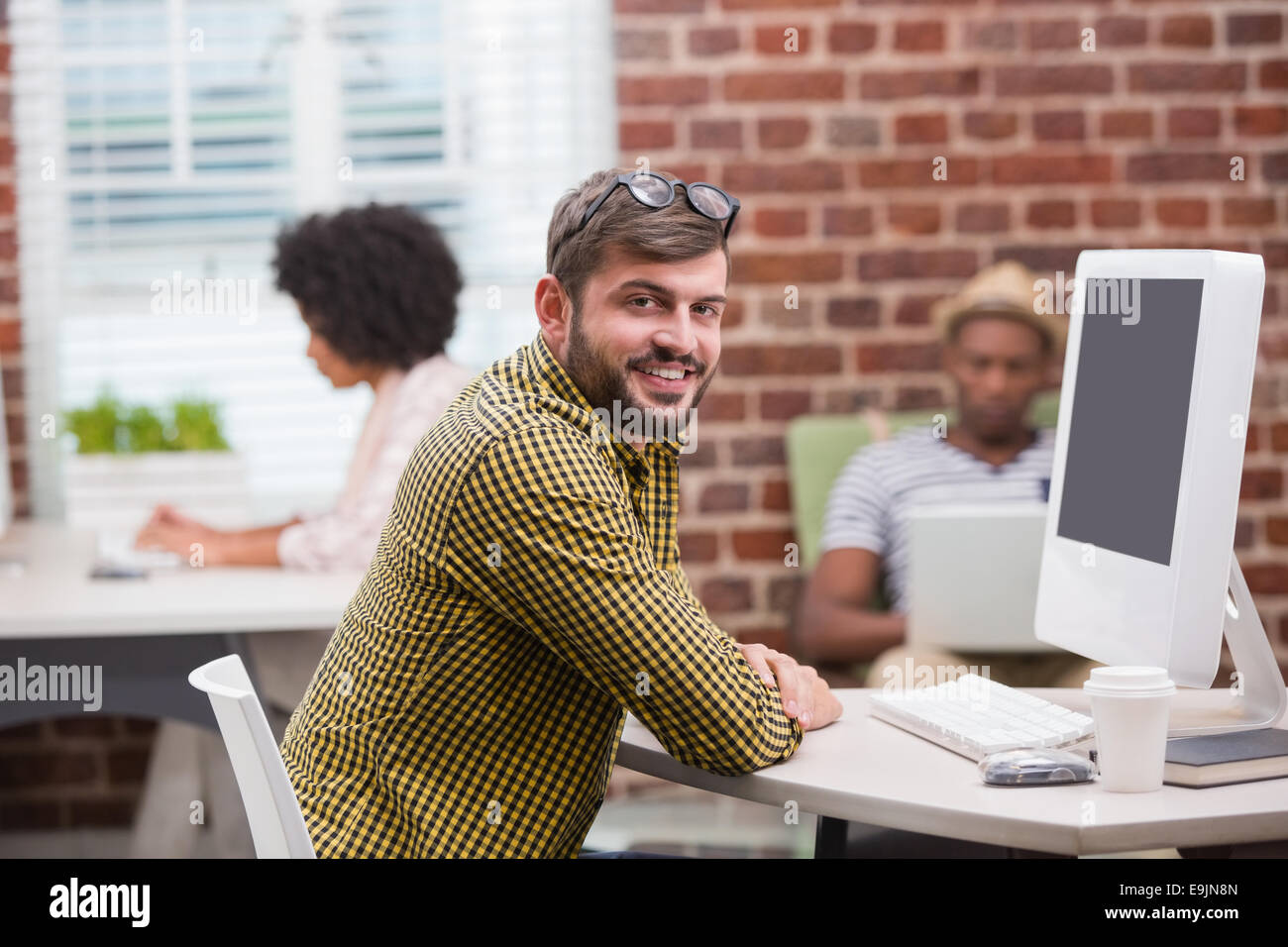 Portrait of casual young man using computer Stock Photo - Alamy