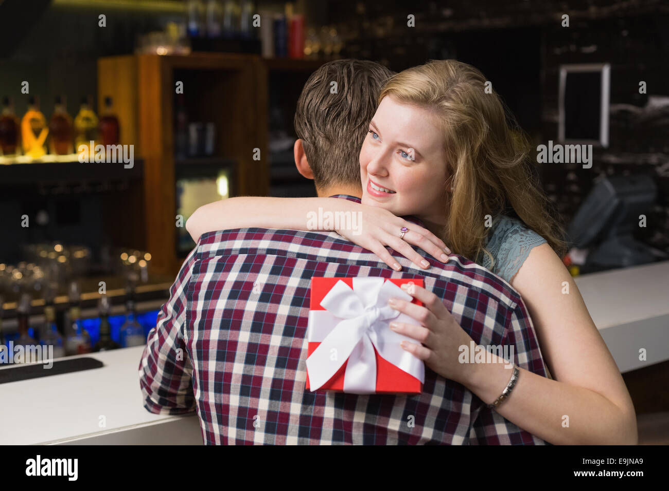 Young couple hugging with a gift Stock Photo - Alamy