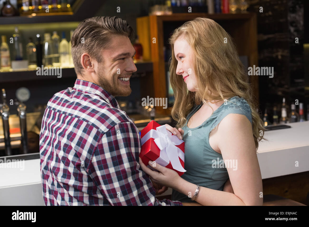 Young couple hugging with a gift Stock Photo - Alamy