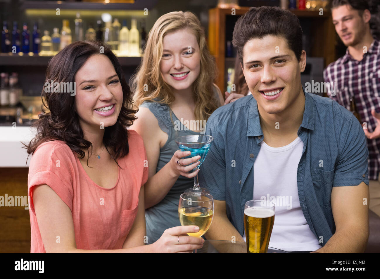 Young friends having a drink together Stock Photo - Alamy