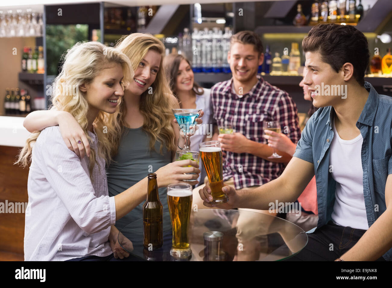 Young friends having a drink together Stock Photo - Alamy