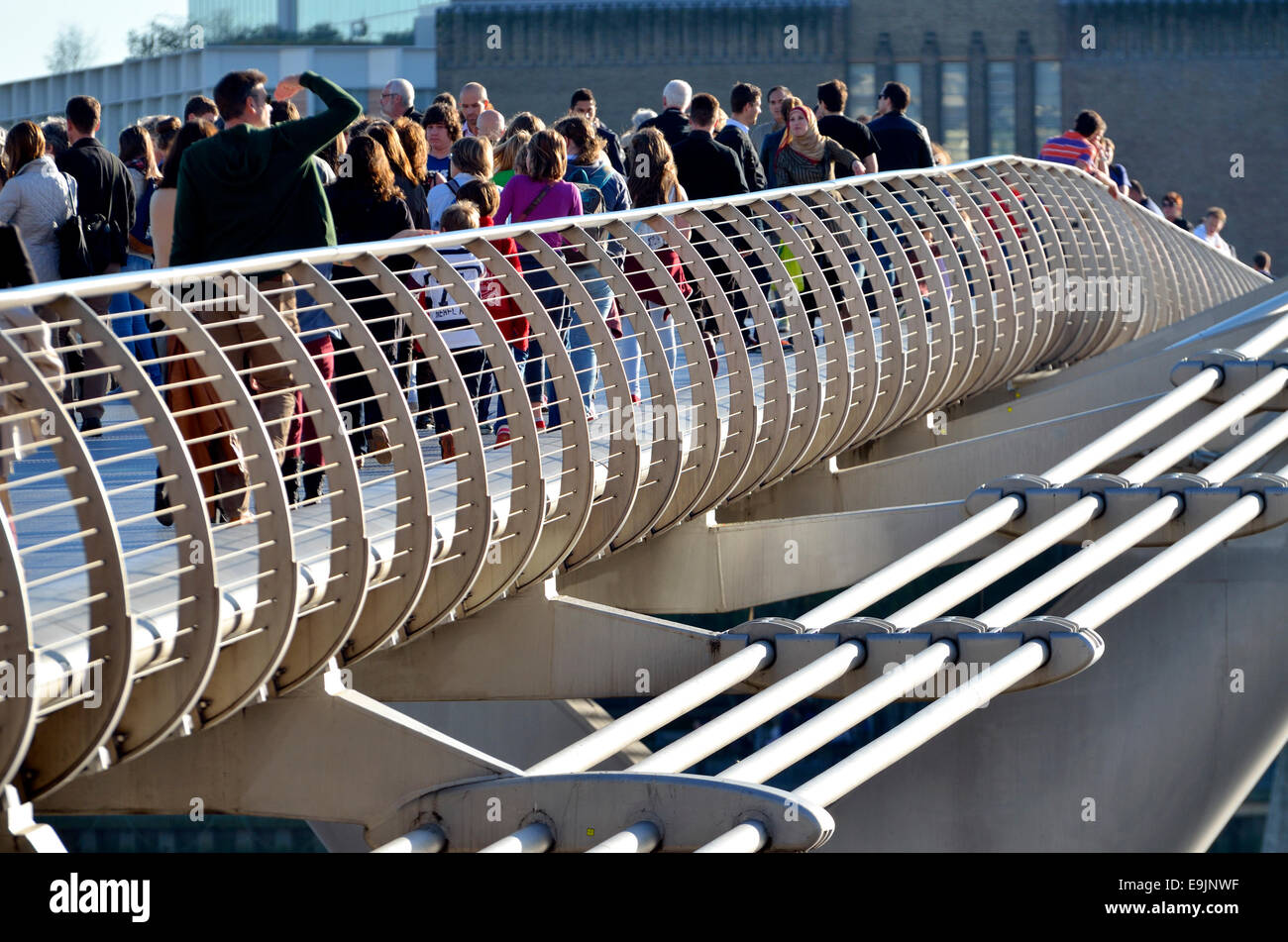 London, England, UK. Crowds crossing the Millennium Bridge, seen from ...