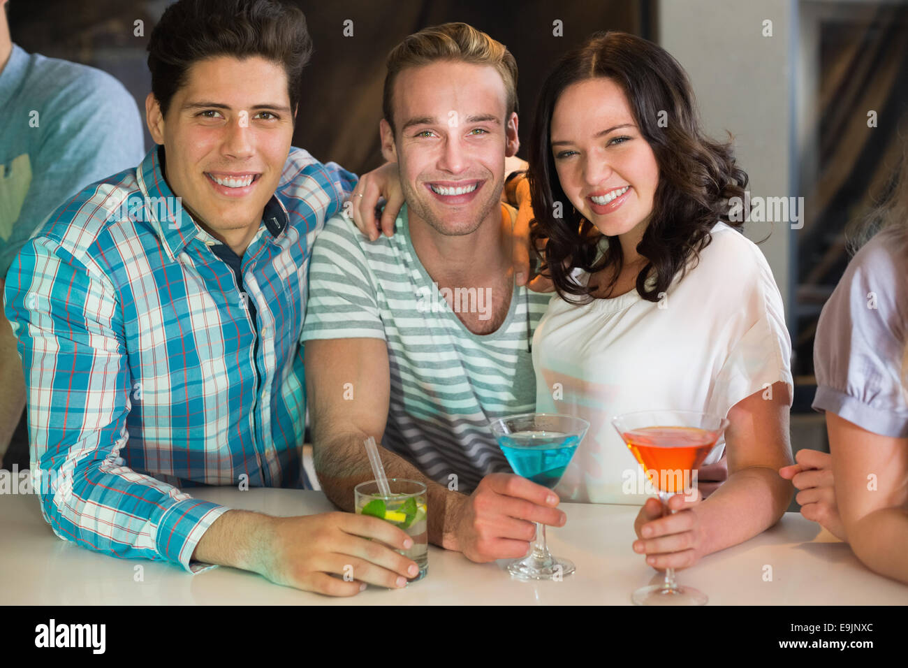 Young friends having a drink together Stock Photo - Alamy