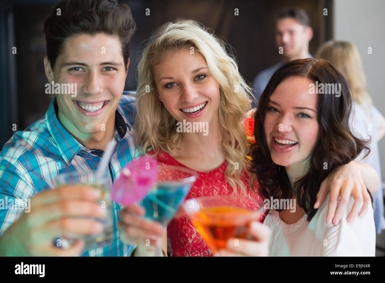 Young friends having a drink together Stock Photo - Alamy