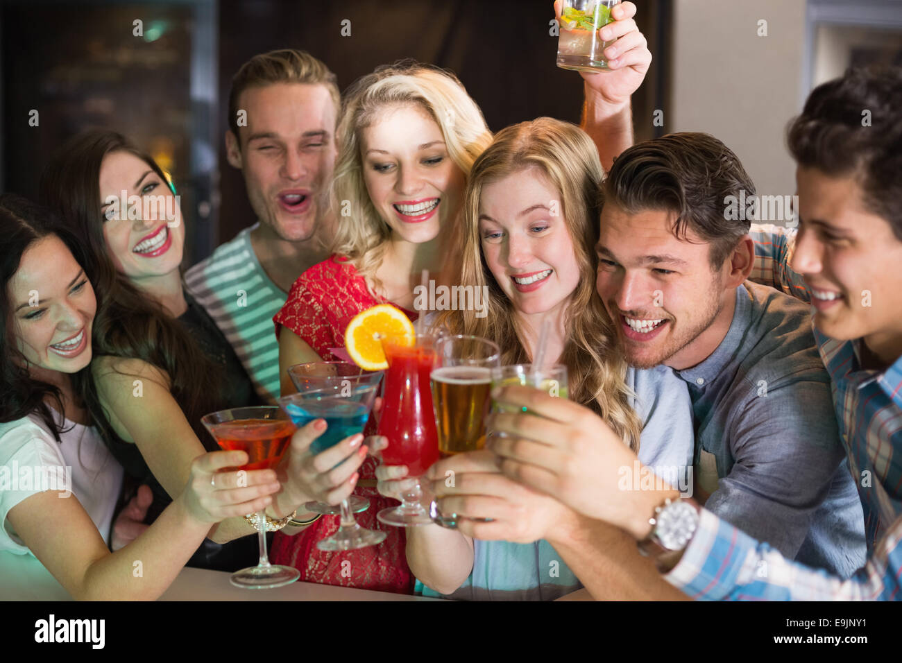 Young friends having a drink together Stock Photo - Alamy