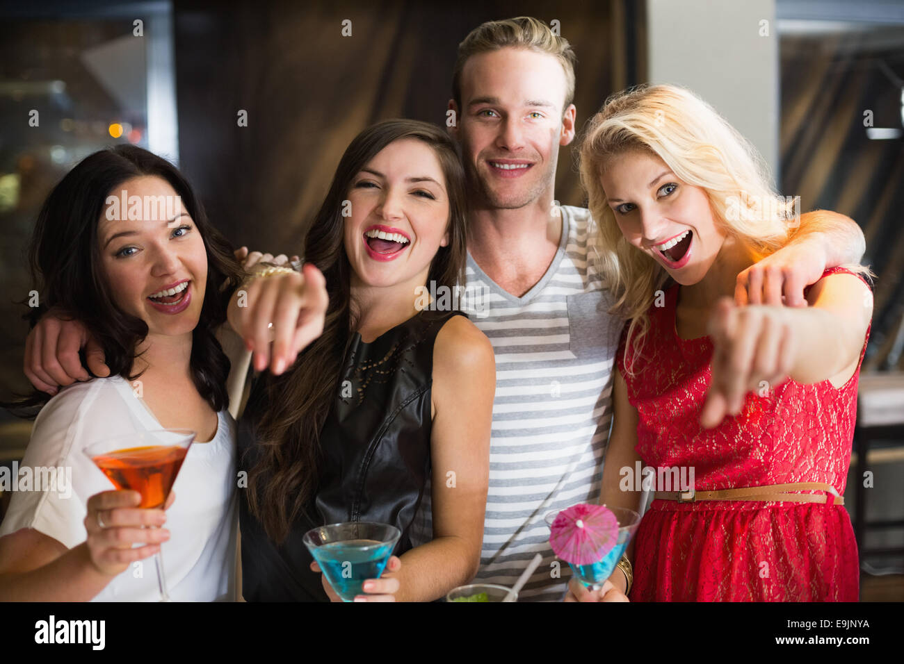 Young friends having a drink together Stock Photo - Alamy