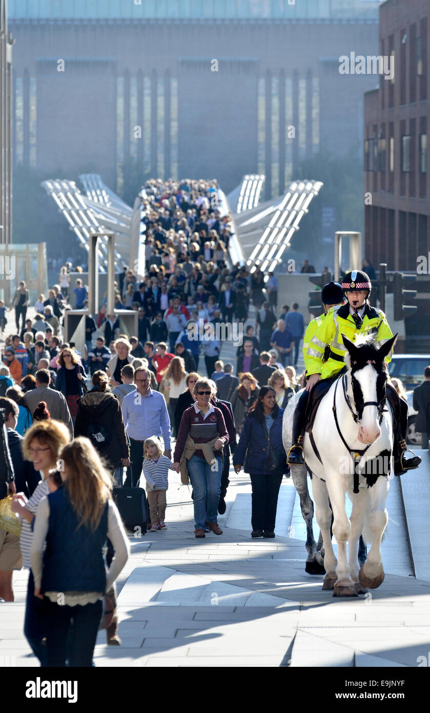 London, England, UK. Crowds crossing the Millennium Bridge, seen from ...