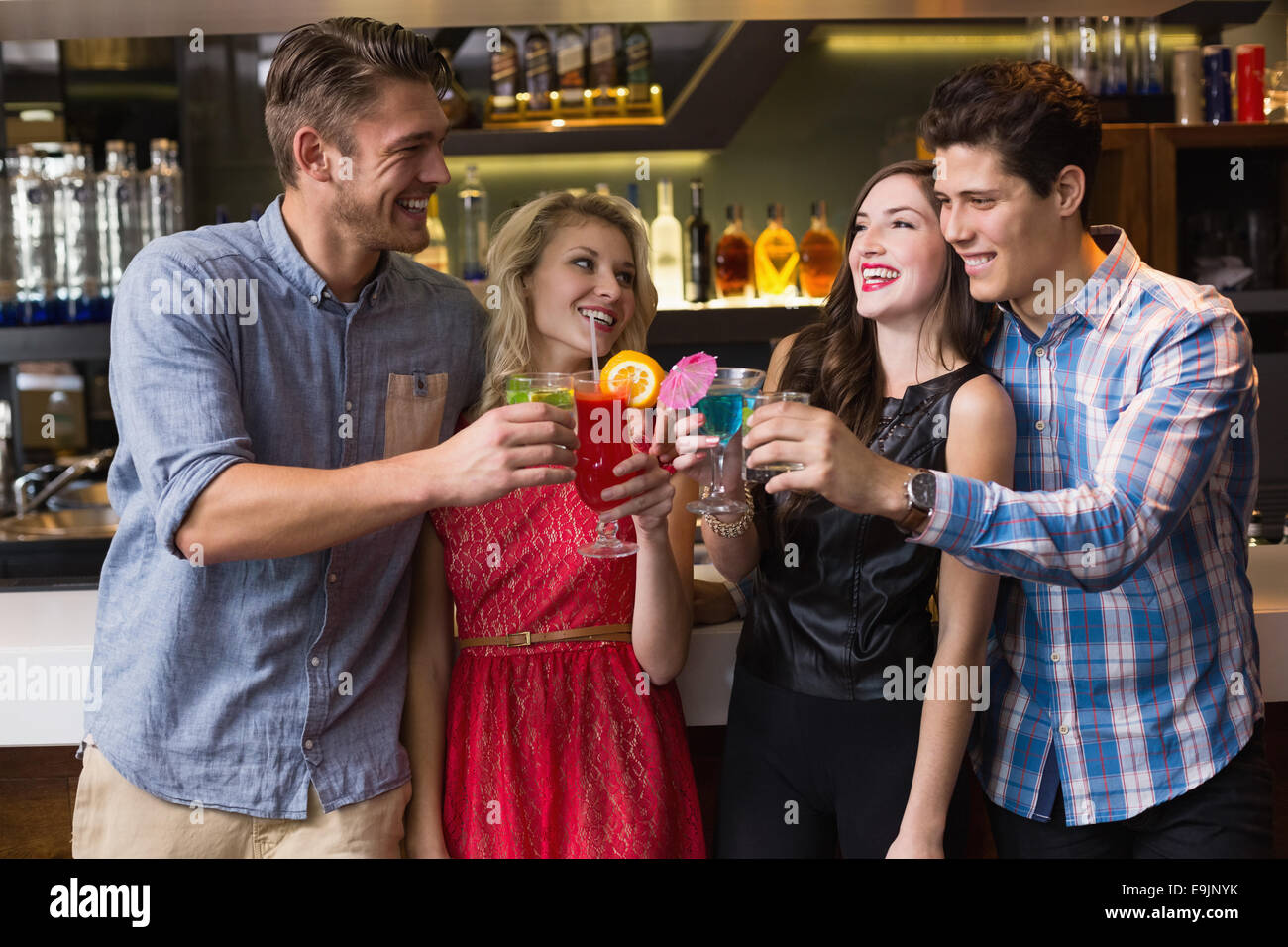 Happy friends drinking cocktails hi-res stock photography and images ...
