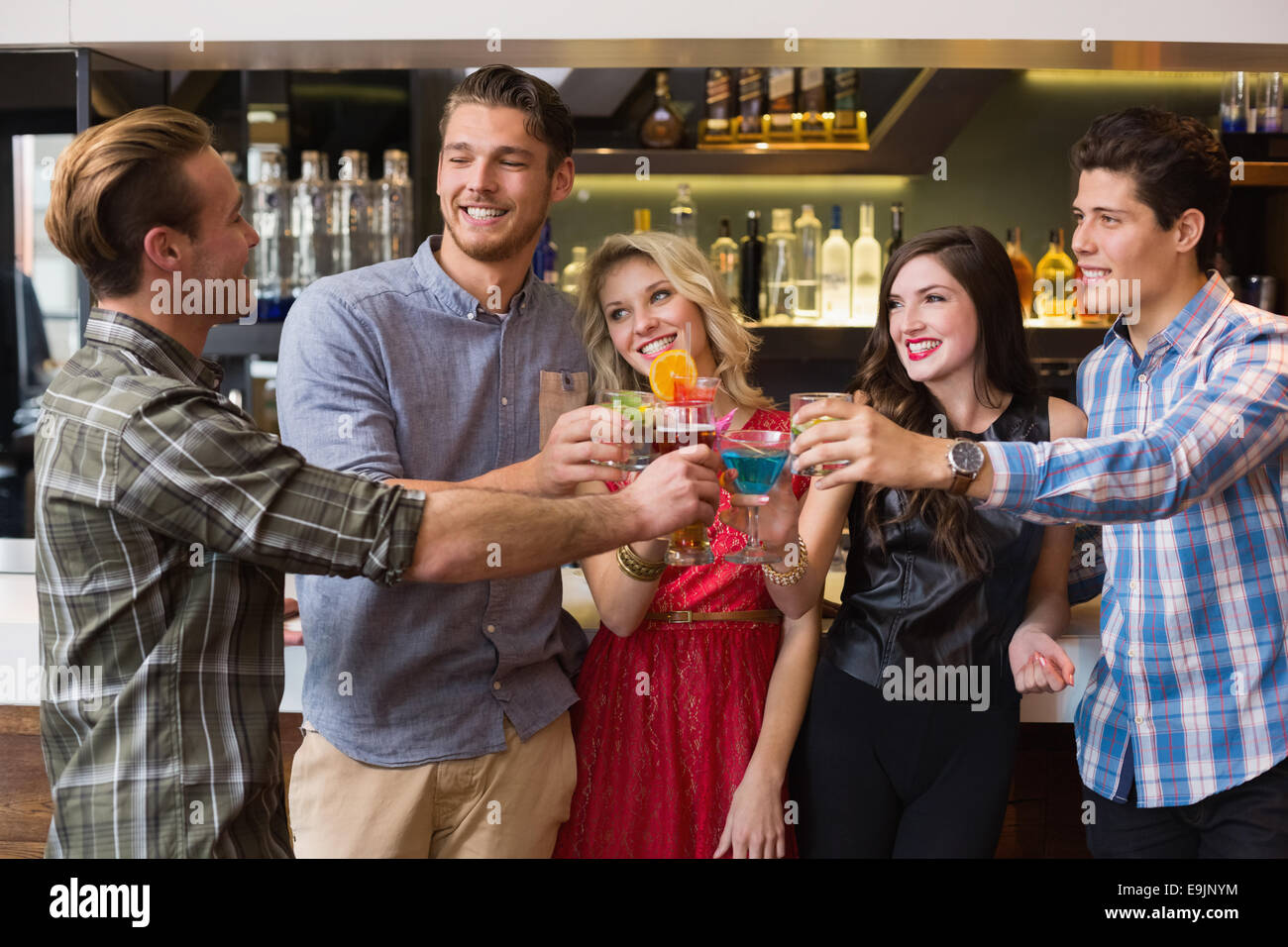 Happy friends drinking cocktails together Stock Photo - Alamy