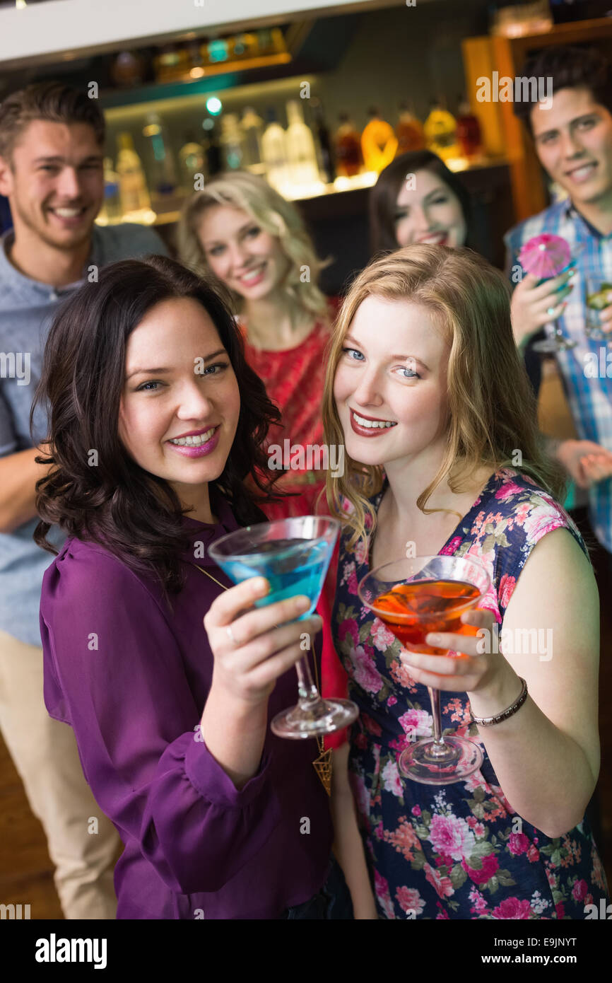 Pretty friends drinking cocktails together Stock Photo - Alamy