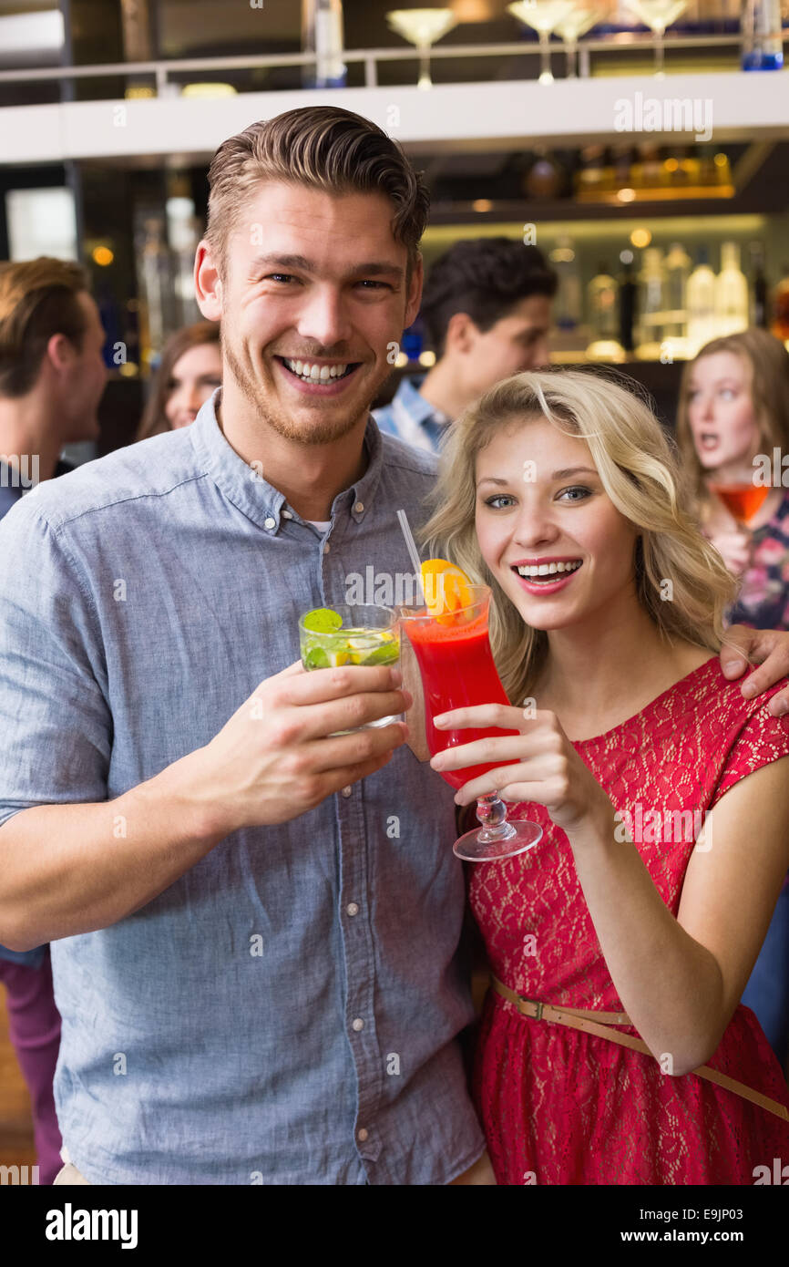 Happy couple drinking cocktails together Stock Photo - Alamy