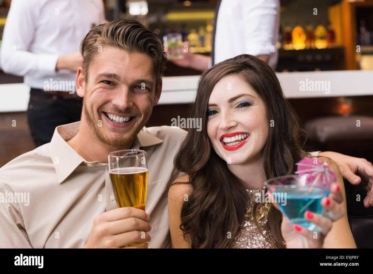 Happy couple having a drink together Stock Photo - Alamy