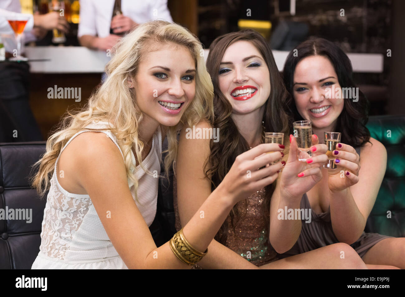 Happy friends drinking shots together Stock Photo - Alamy